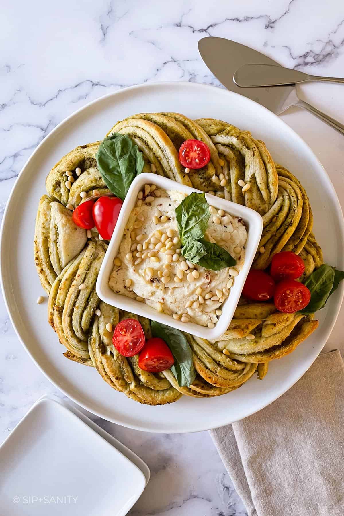 Pesto Bread Wreath + Goat Cheese Spread • Sip + Sanity